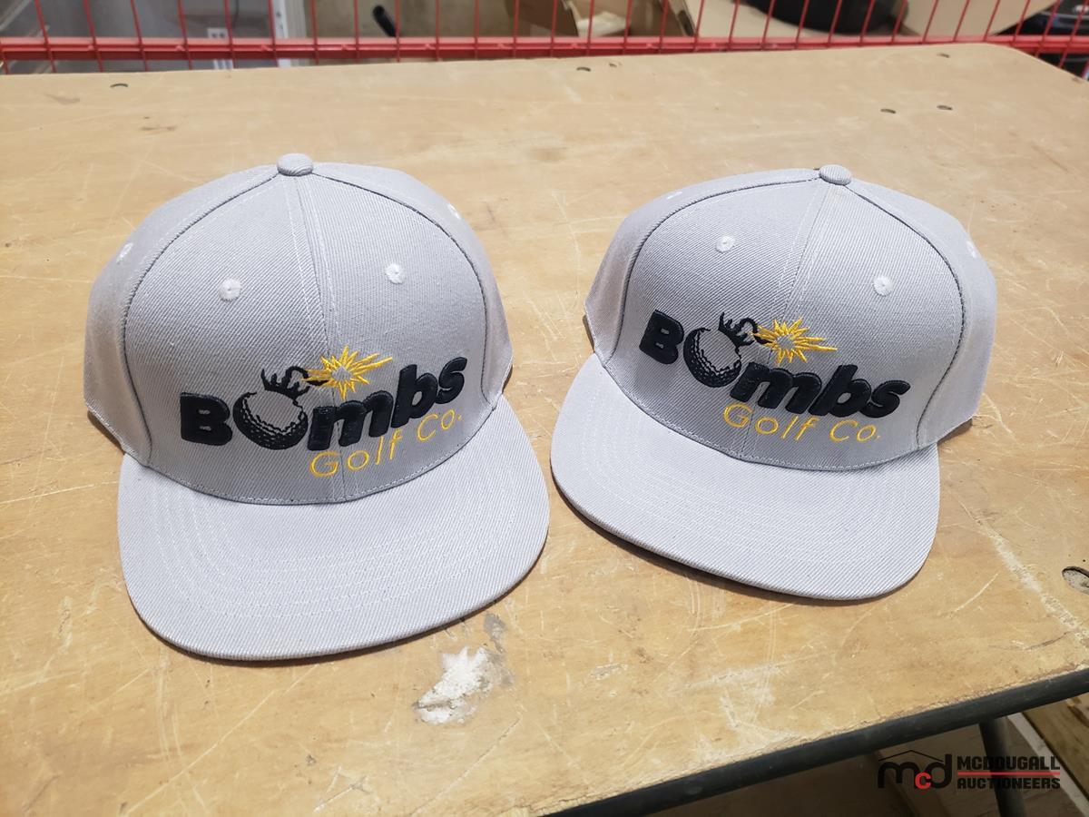 (10) Cases of a Dozen Golf Balls, (2) Bomb Golf Co. Hats & (8) Golf Divots